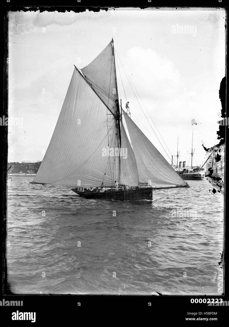 A gaff cutter, possibly named ERA, is sailing on Sydney Harbour. This ...