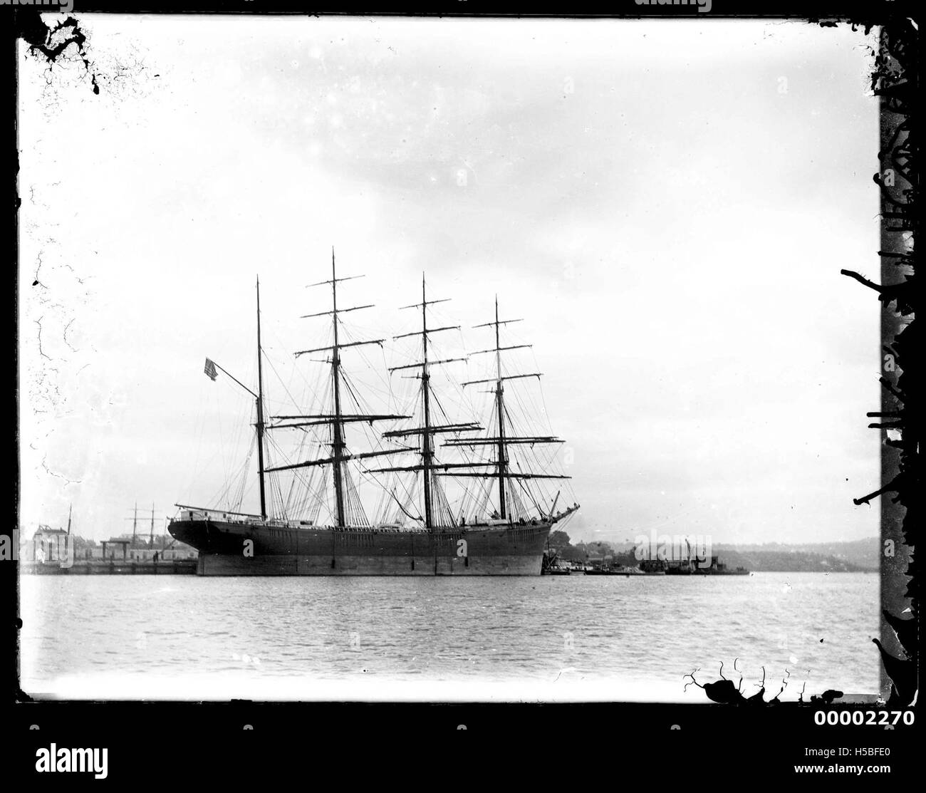 A photograph of a four-masted barque sailing on Sydney Harbour. This ...