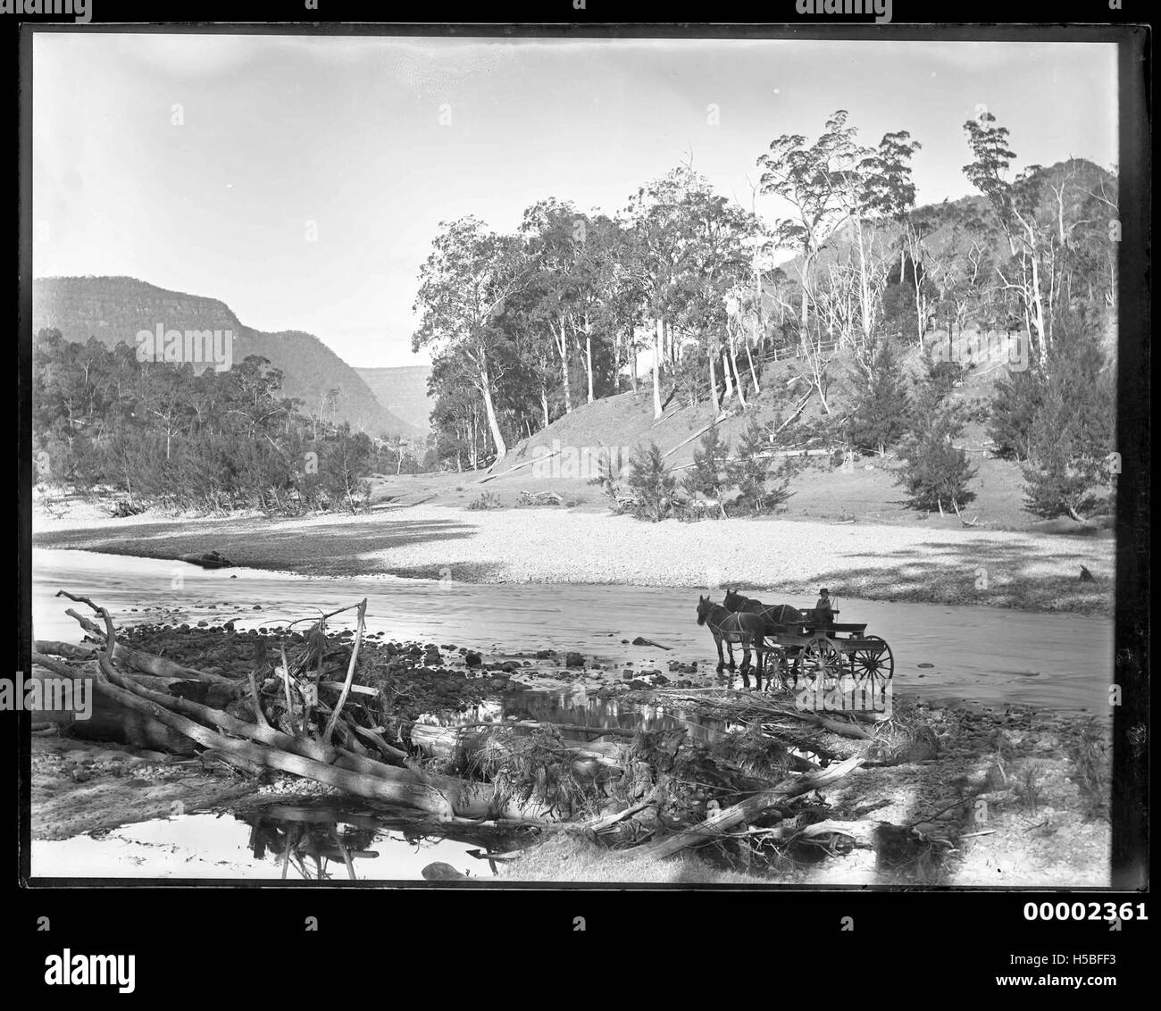 A historical image showing a carriage near a river, potentially the ...