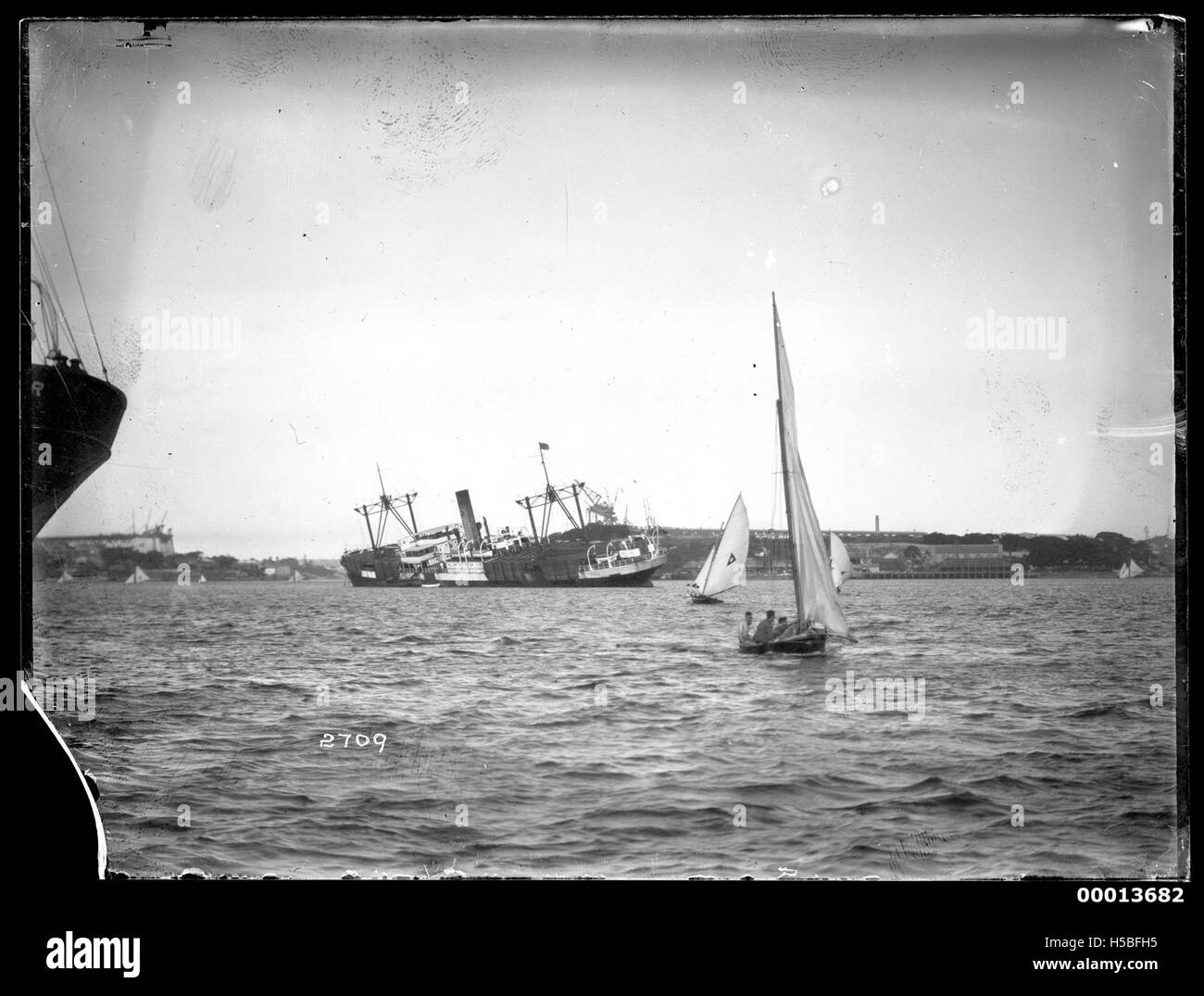 Cargo steamer listing portside Stock Photo - Alamy