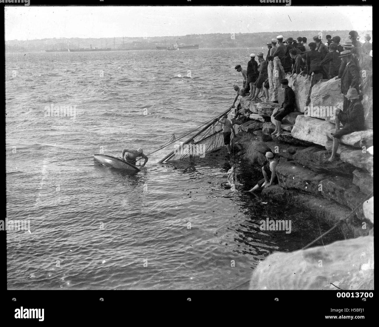 A photograph showing a capsized skiff being dragged to shore at Clark ...