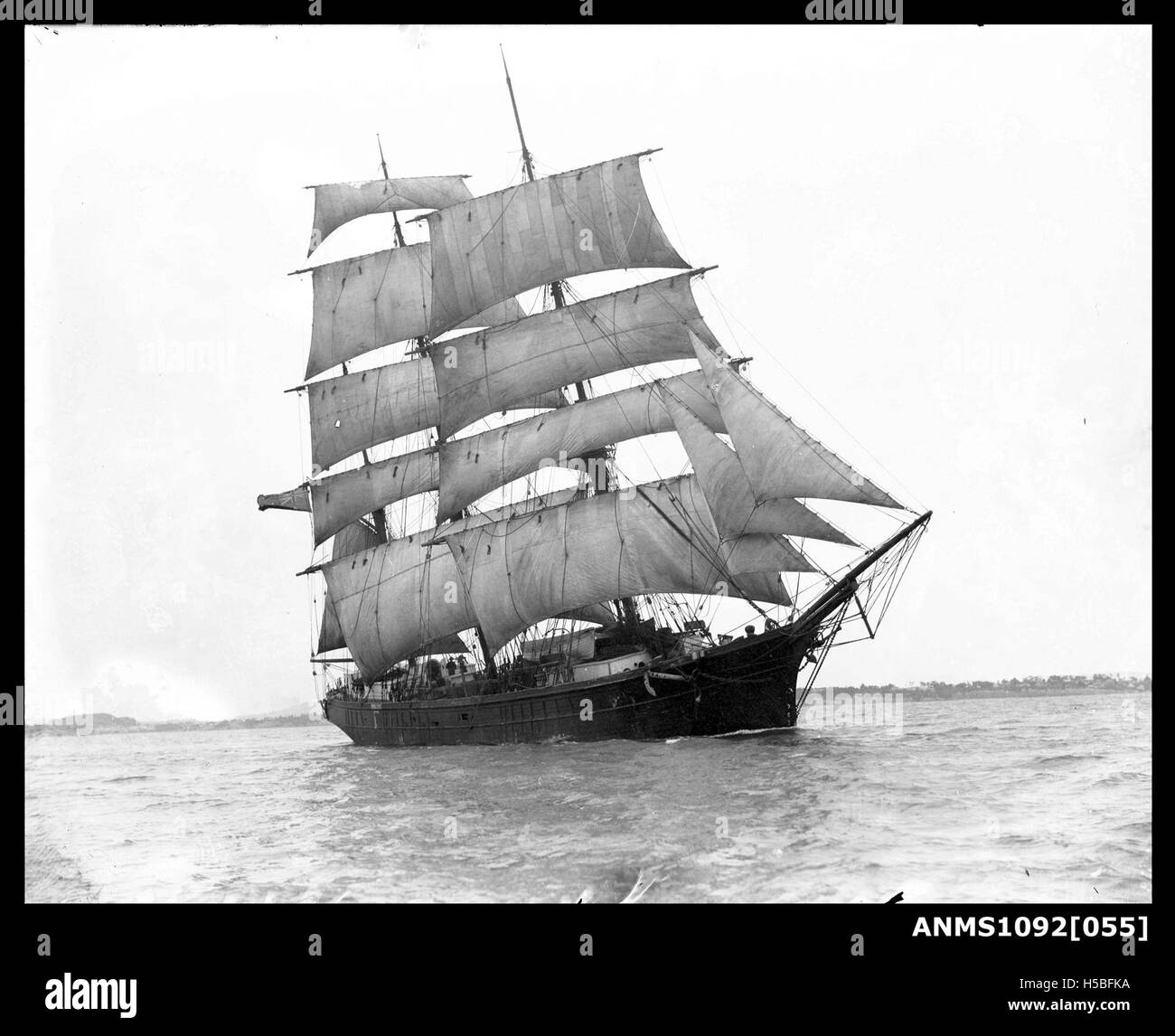 A three-masted barque is seen underway with its sails set, possibly on ...
