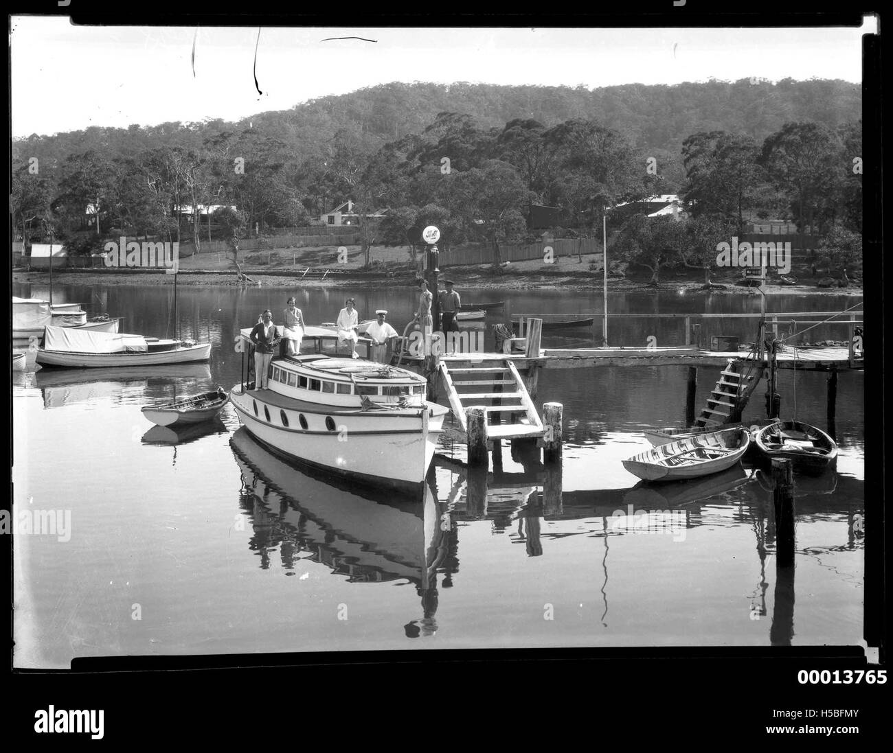 A motor launch, likely a small boat or vessel, is seen refueling at a ...