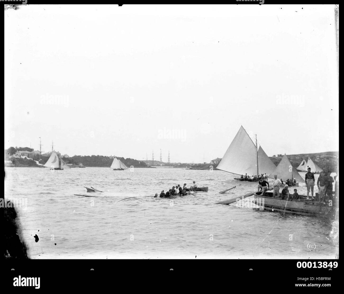 A skiff capsizes on Sydney Harbour, a common occurrence in sailing ...