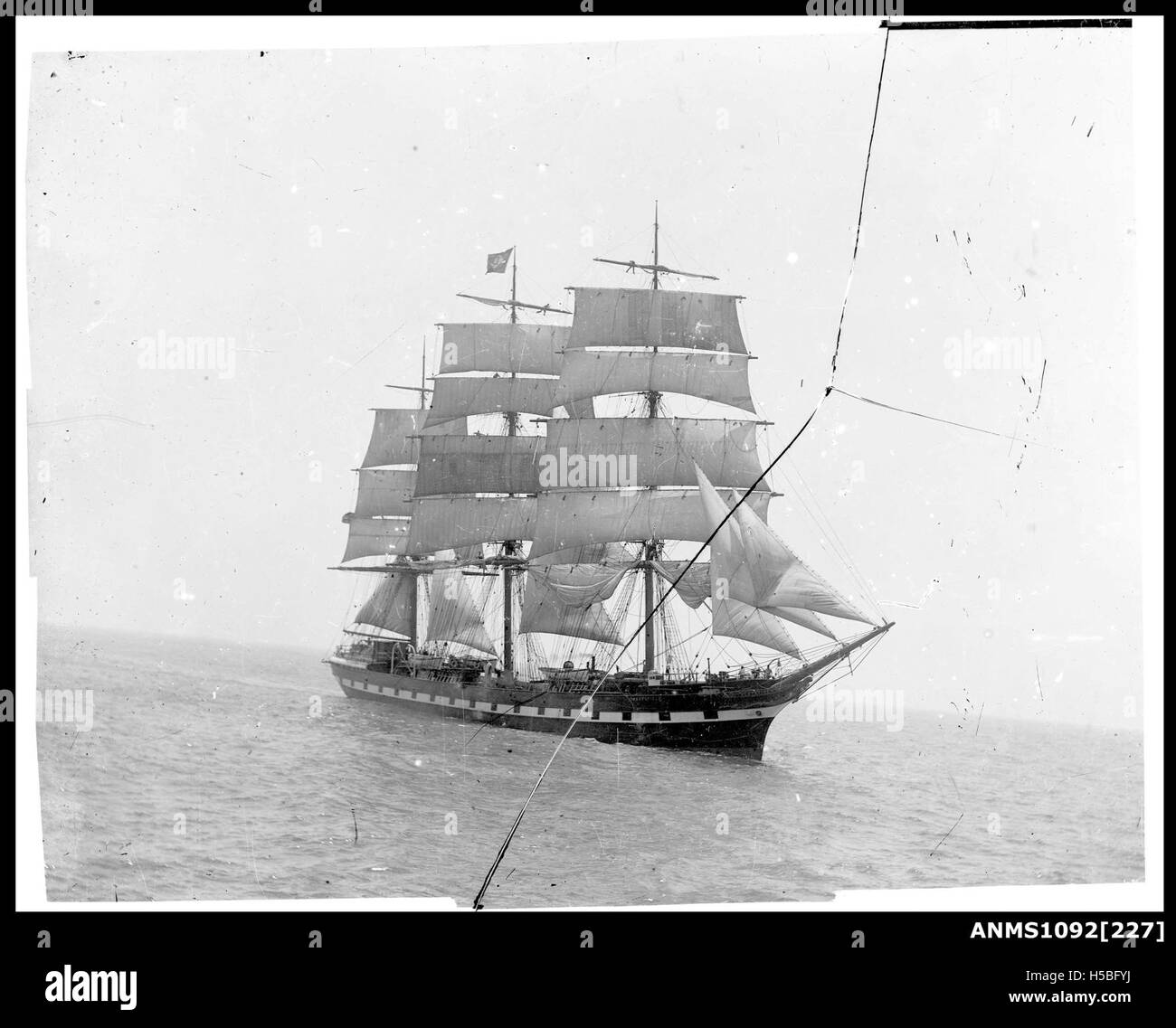 A sailing ship is underway, setting sail with its sails fully deployed ...