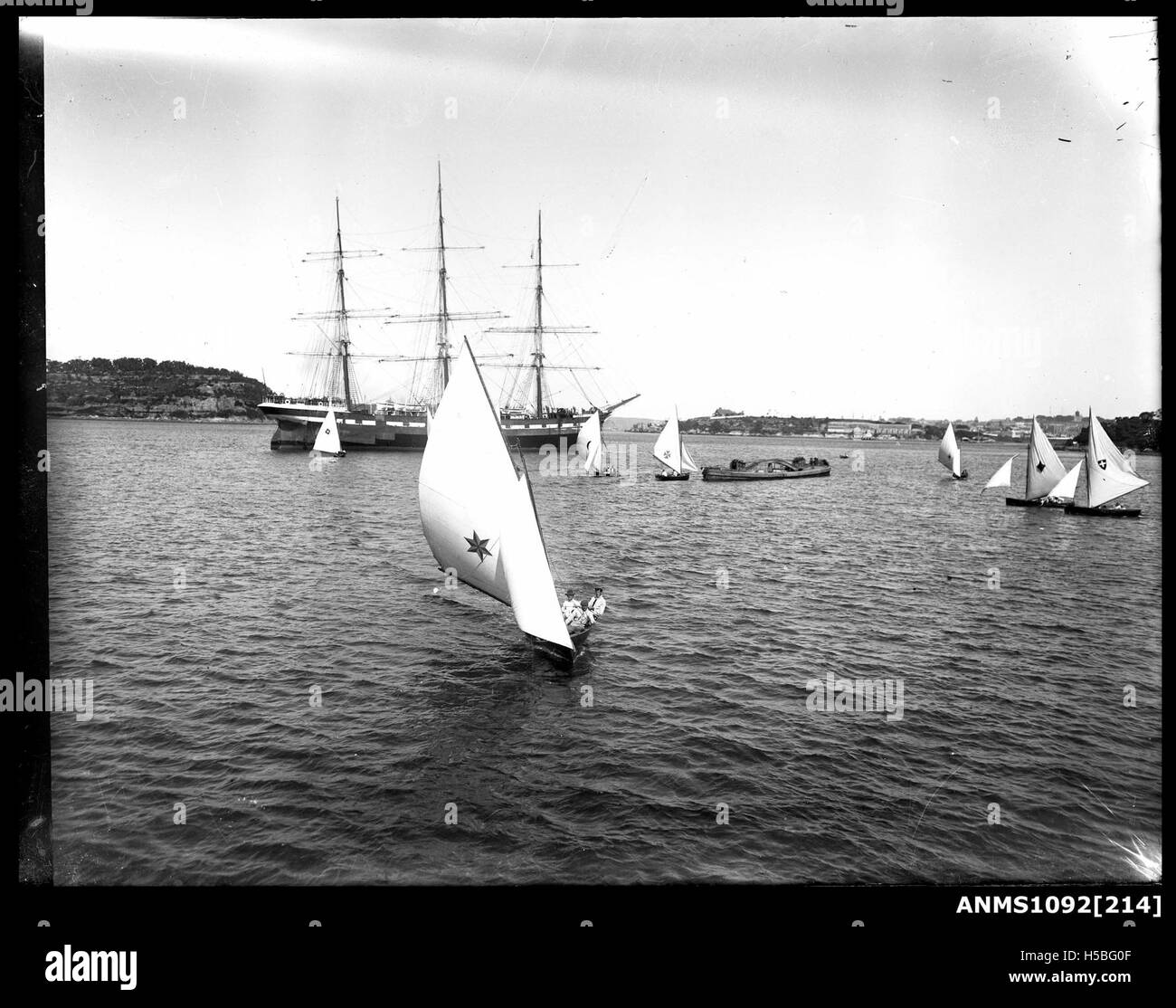 This historical photograph shows a three-masted full-rigged ship at ...