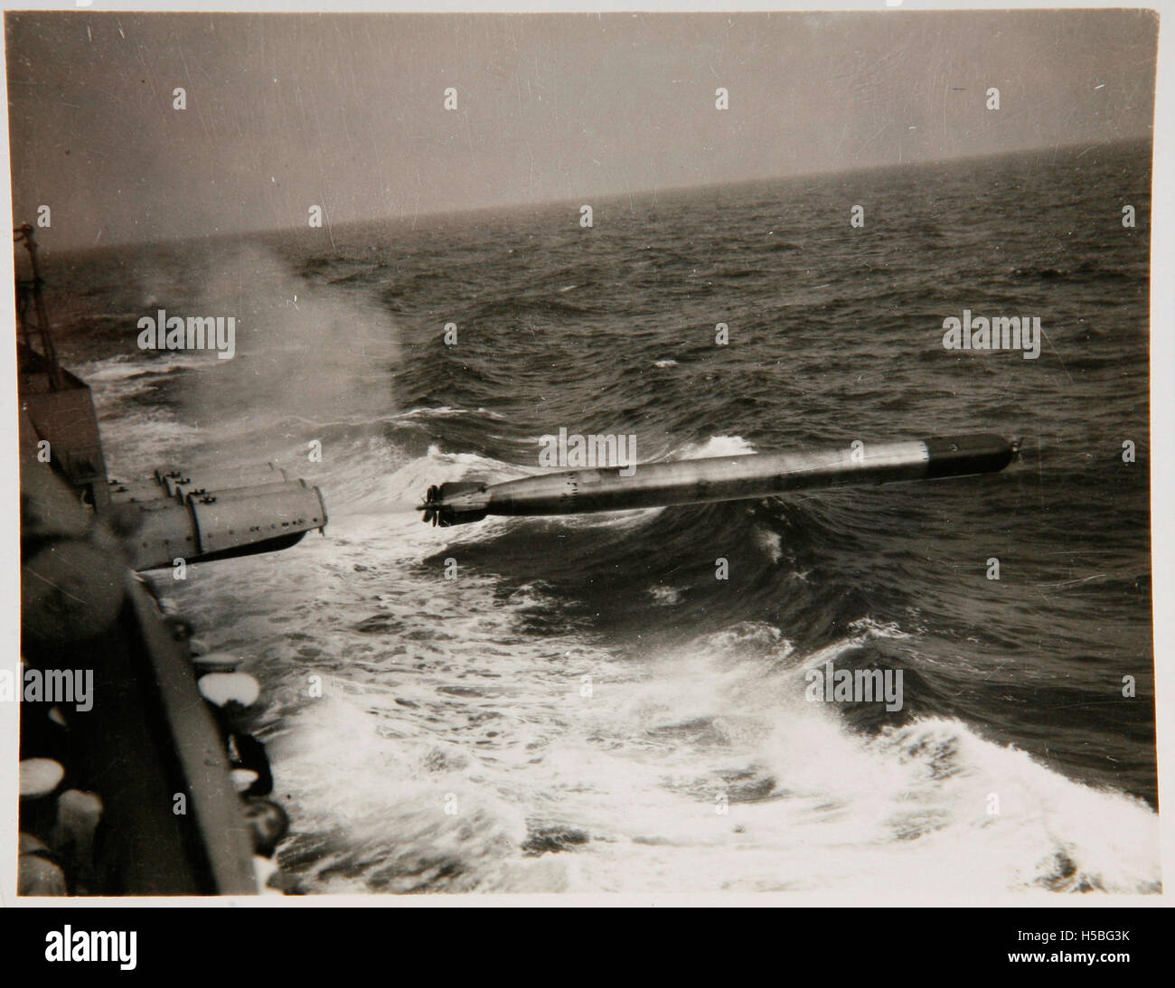A torpedo is fired from the Australian warship HMAS AUSTRALIA in the ...