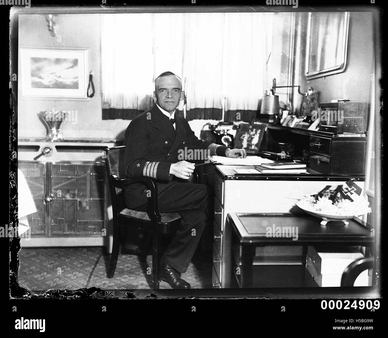 Captain Otto Schniewind is shown in his cabin aboard the German cruiser ...
