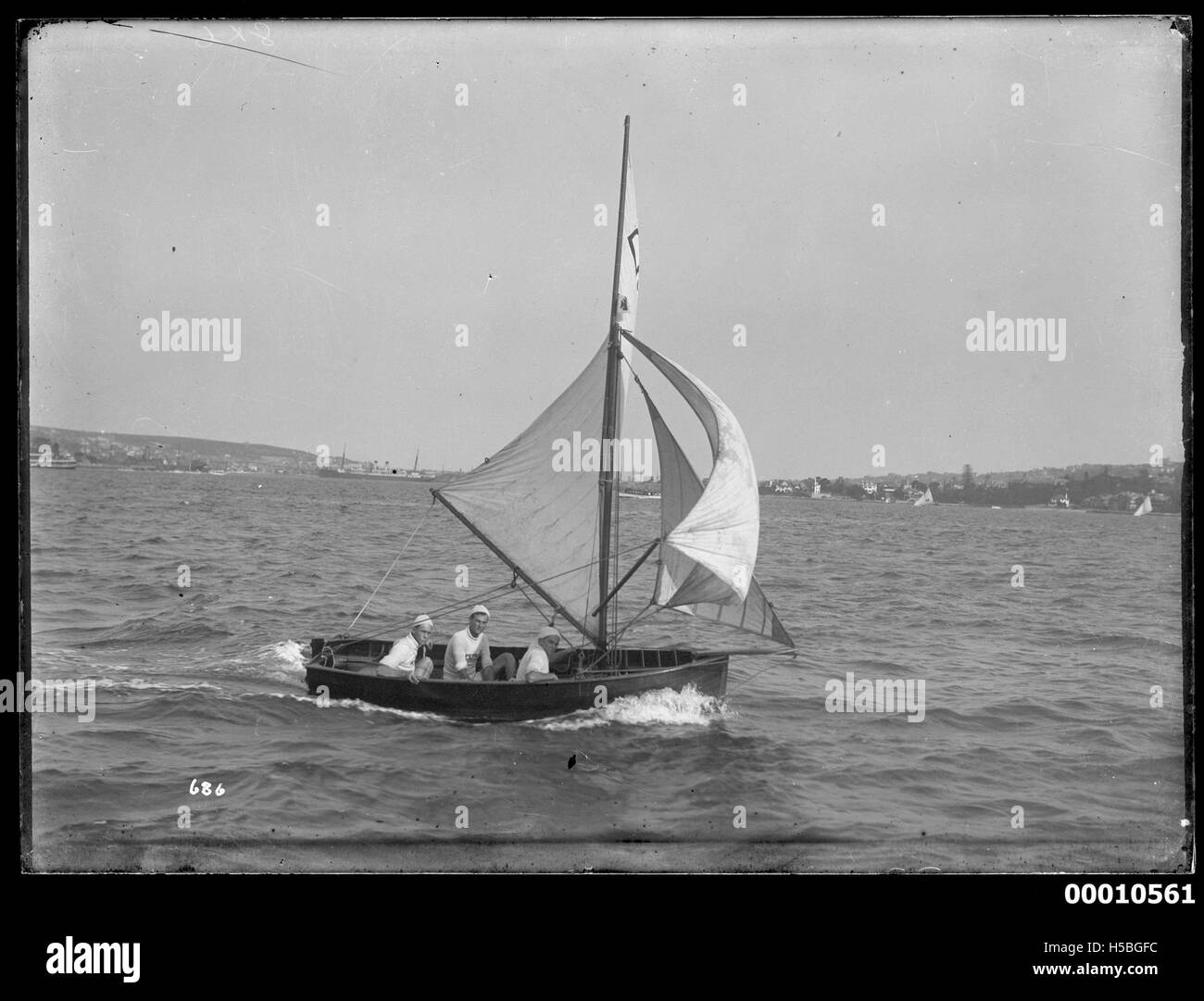 A photograph of a 10-footer sailing boat on Sydney Harbour, showcasing ...