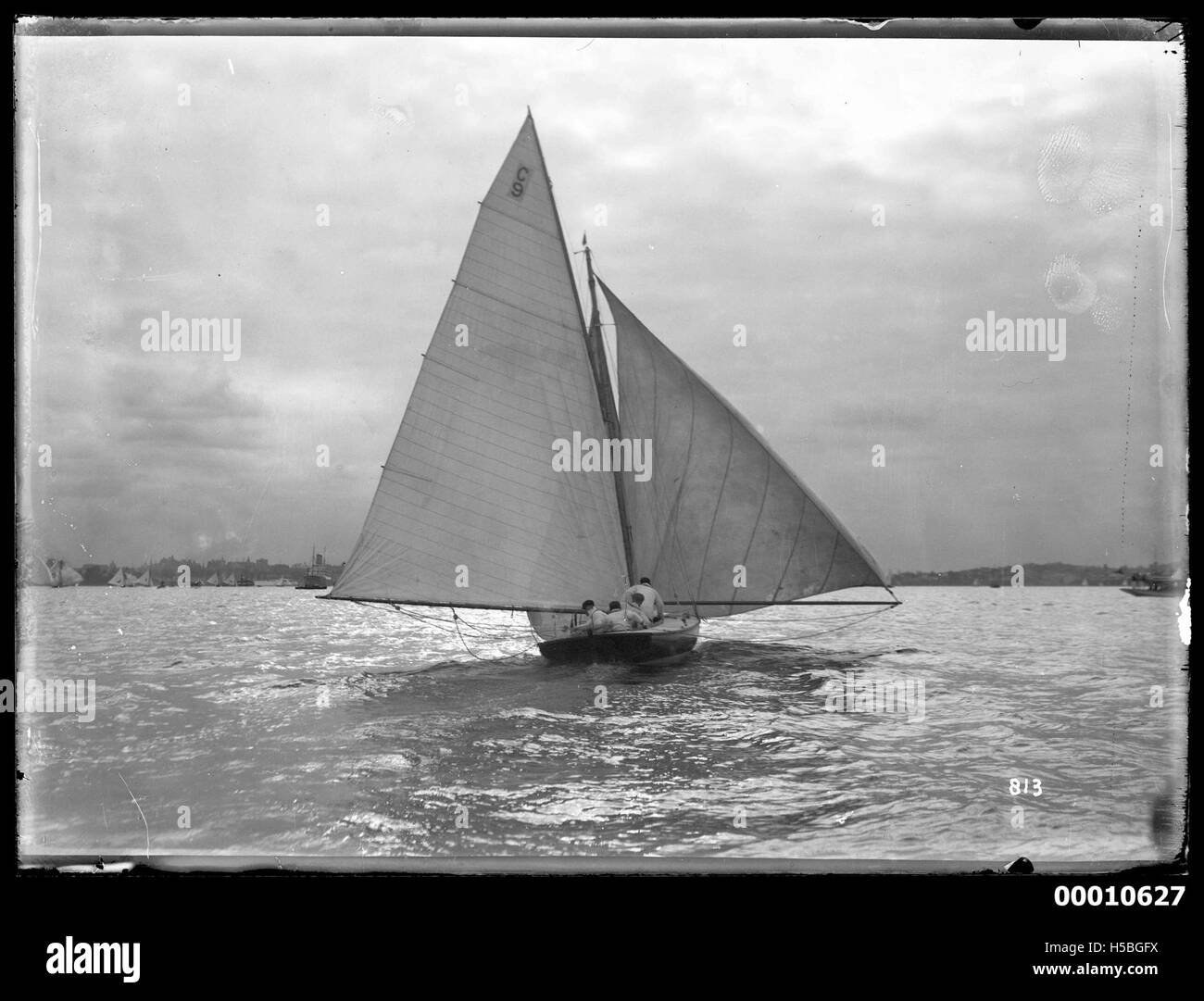 A yacht is seen sailing on Sydney Harbour, showcasing the beauty of the ...