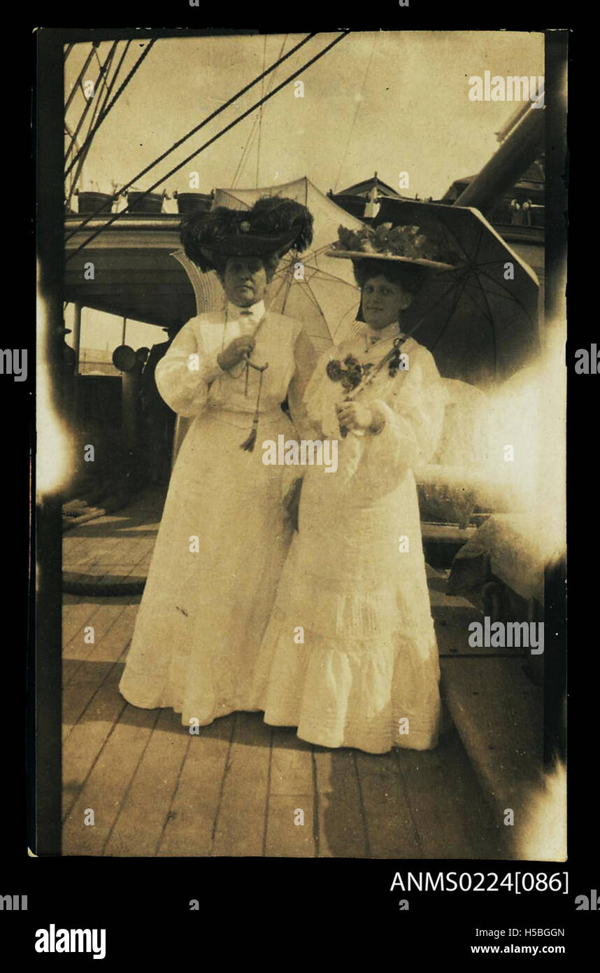 A photograph of two women standing on the deck of an unknown ship ...