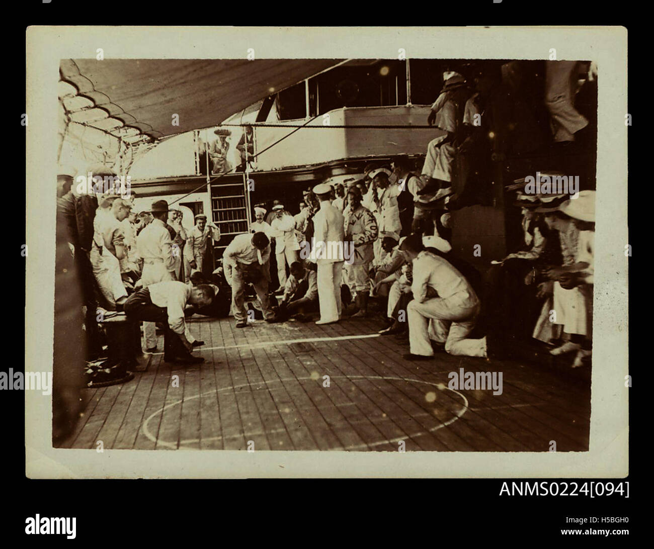 Crew and passengers are seen enjoying a game on the deck of a ship ...