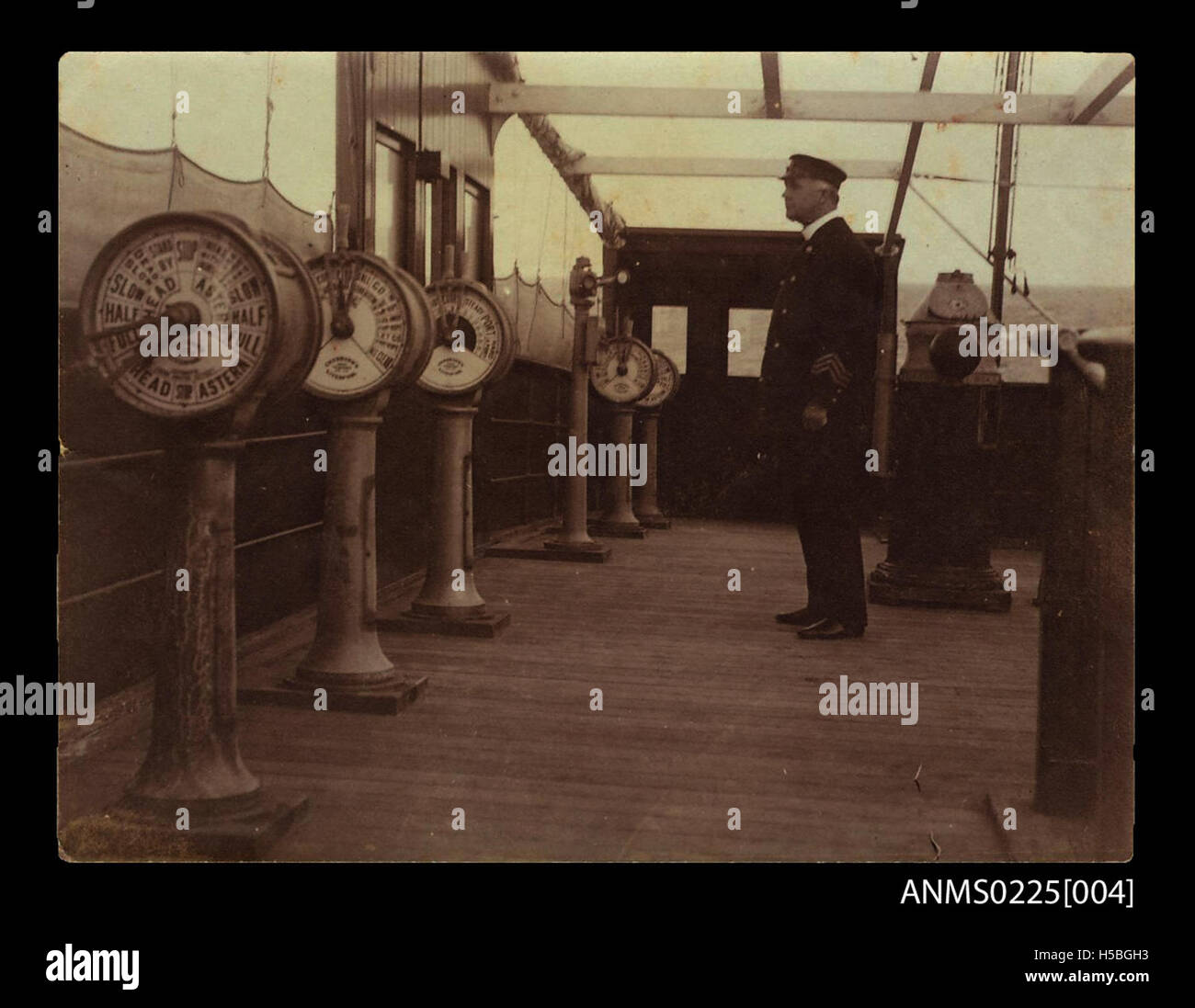 A captain, possibly W.L. Smith, is seen standing on the bridge of a ...