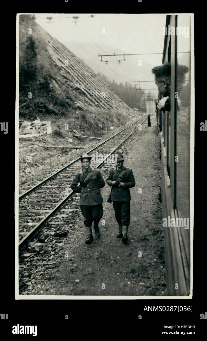 A photograph of border guards positioned beside a train at the Italian ...