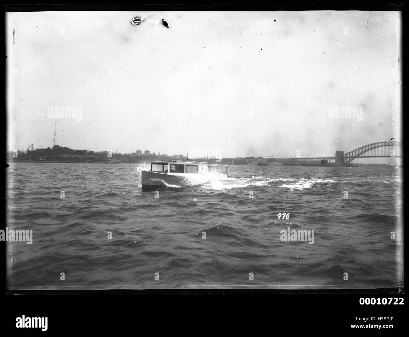 A motor launch is seen with the Sydney Harbour Bridge in the background ...