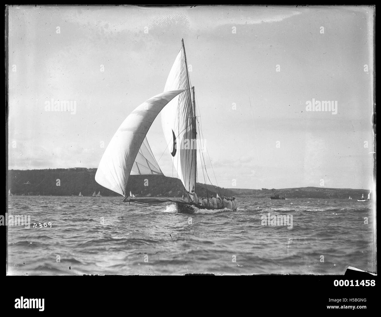 A yacht is seen sailing across Sydney Harbour, one of the most iconic ...