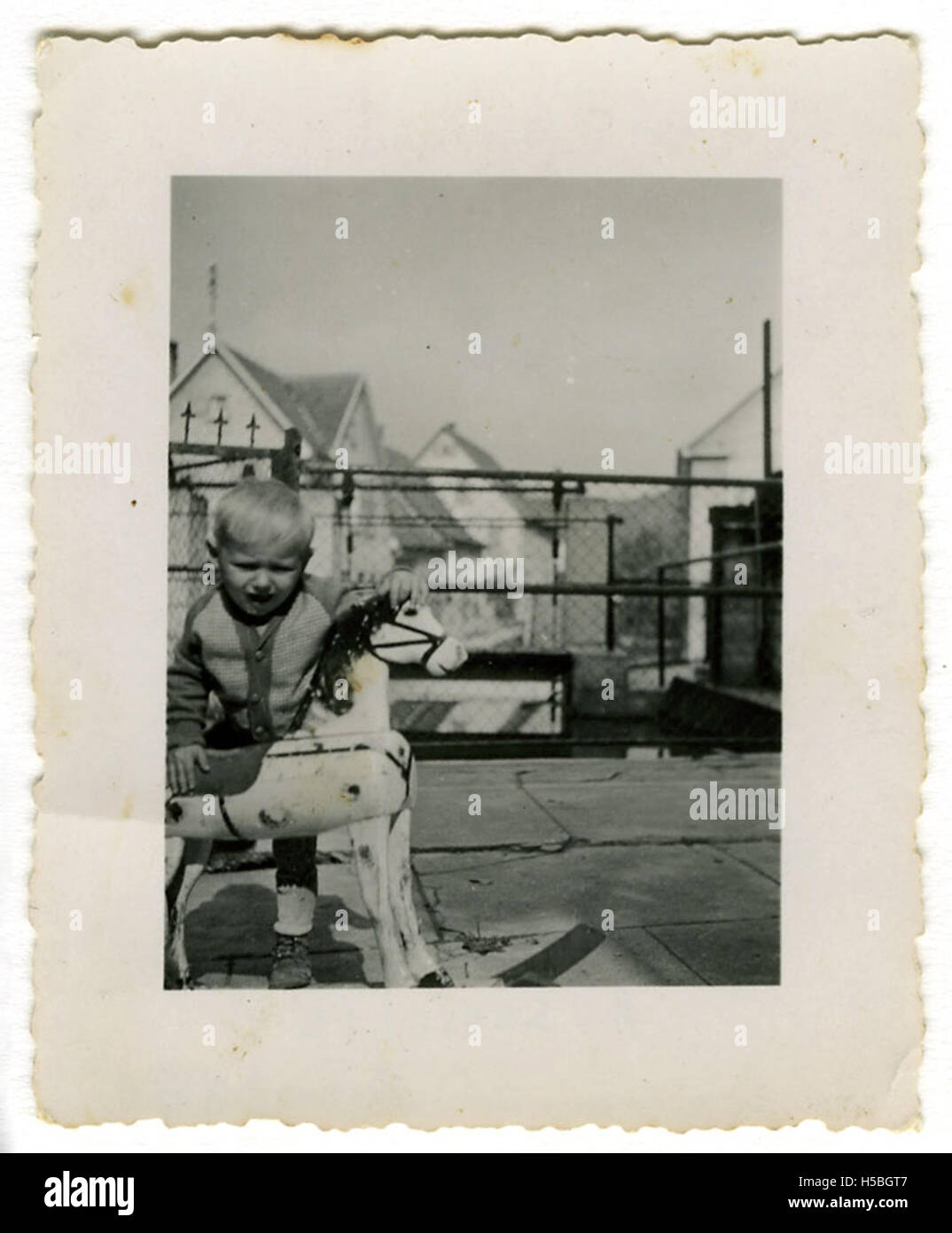 A portrait of Alfonsas Savickis, a young Lithuanian migrant, holding a ...