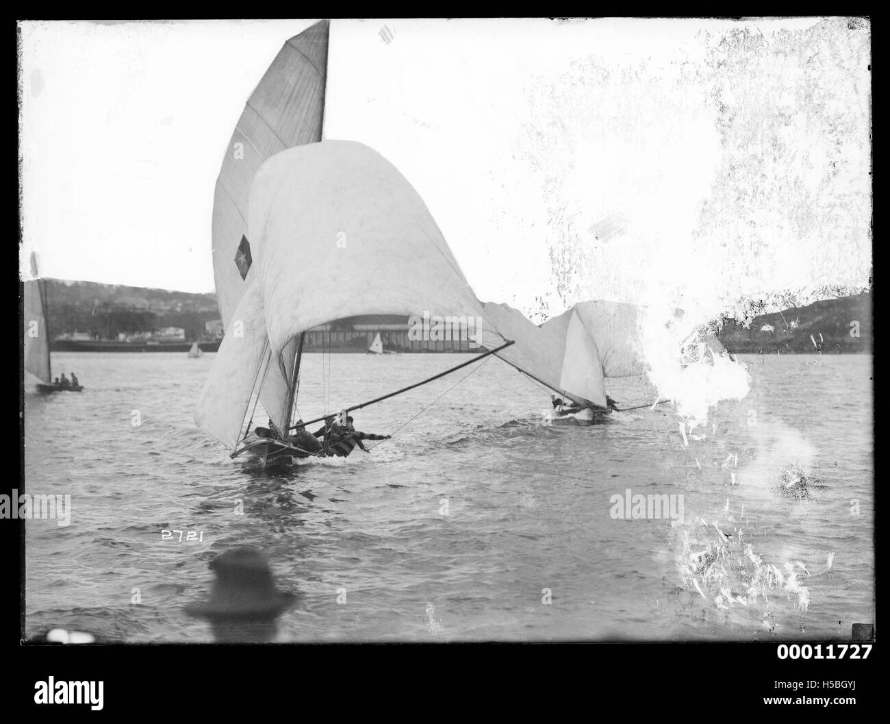 A sloop is seen on Sydney Harbour, showcasing the maritime activity in ...