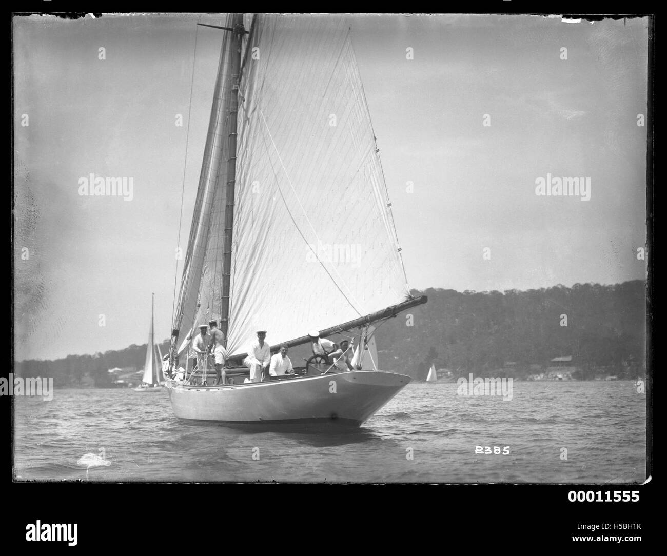 This photograph shows a sloop, a type of small sailing vessel, on a ...