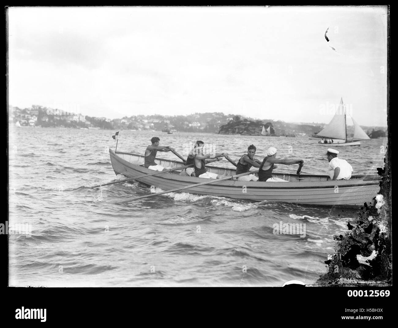 A rowboat is depicted, likely associated with surf life saving ...
