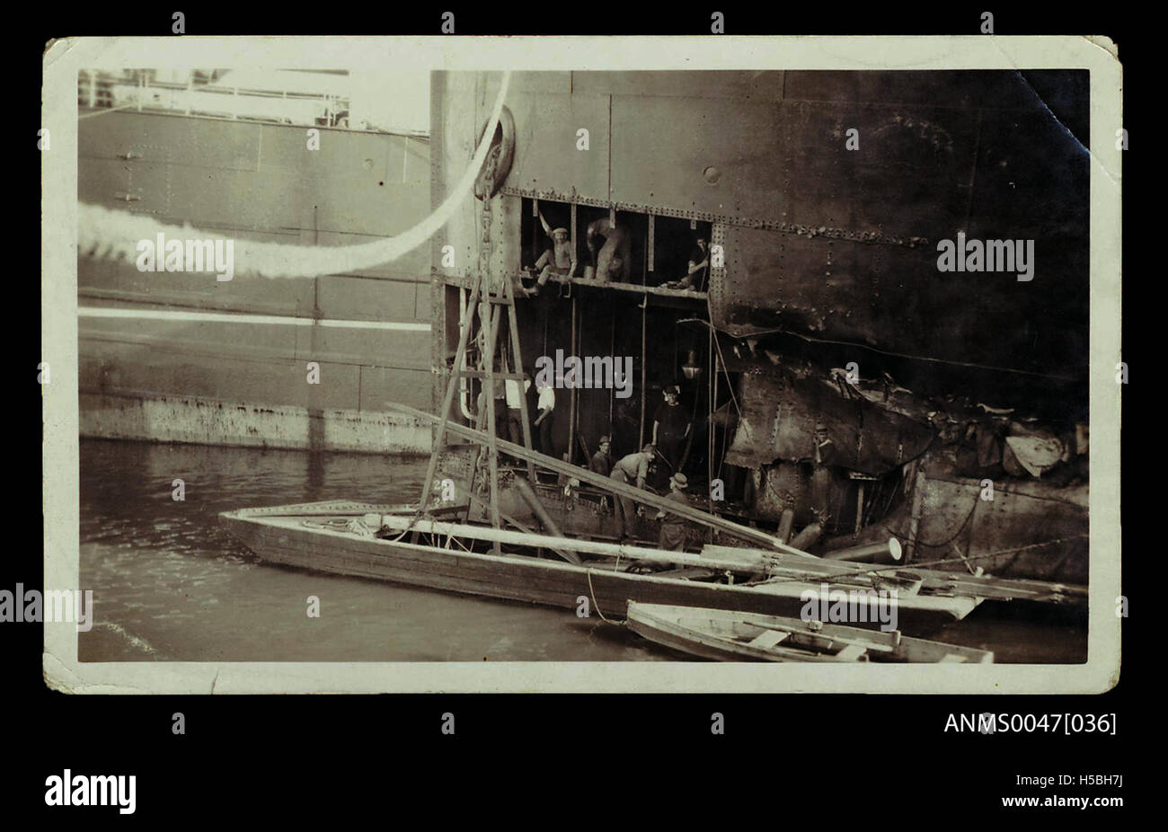 Image capturing workers conducting repairs on the port bow of an ...