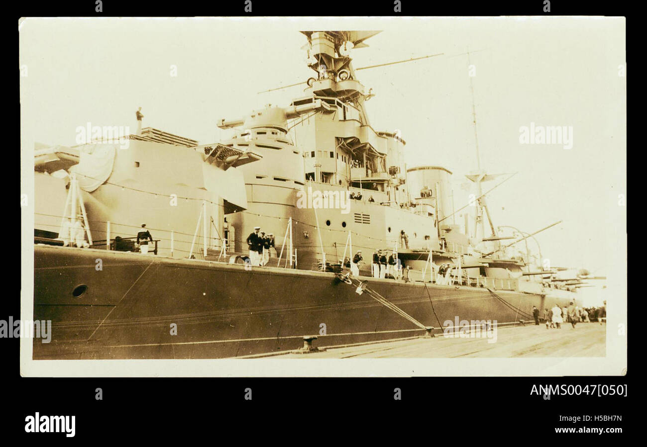 HMS Hood, a British battlecruiser, is shown docked at a wharf in 1926 ...