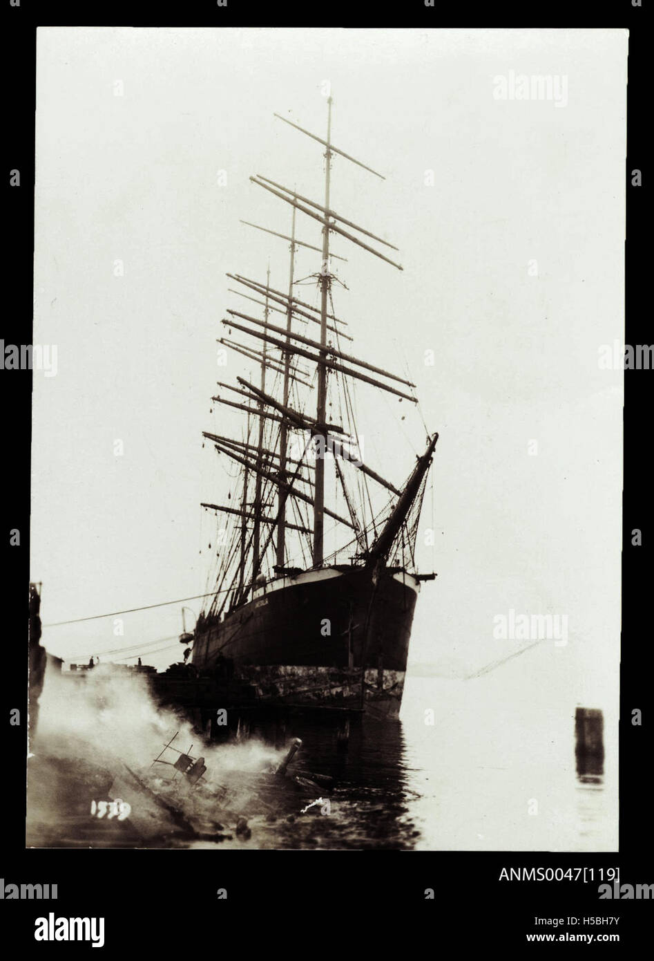 A photograph of the four-masted ship James Dollar docked at a wharf ...