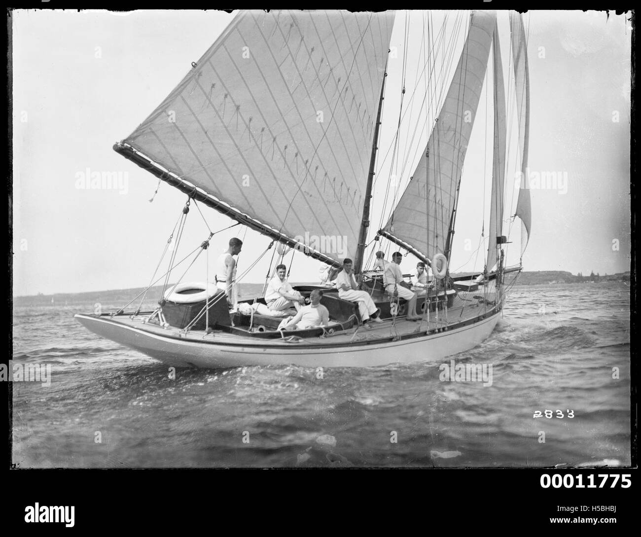 A schooner, a type of sailing vessel, is depicted on Sydney Harbour ...