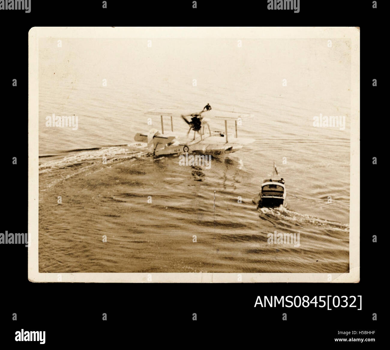 A photograph of a seaplane, likely in flight or preparing for takeoff ...