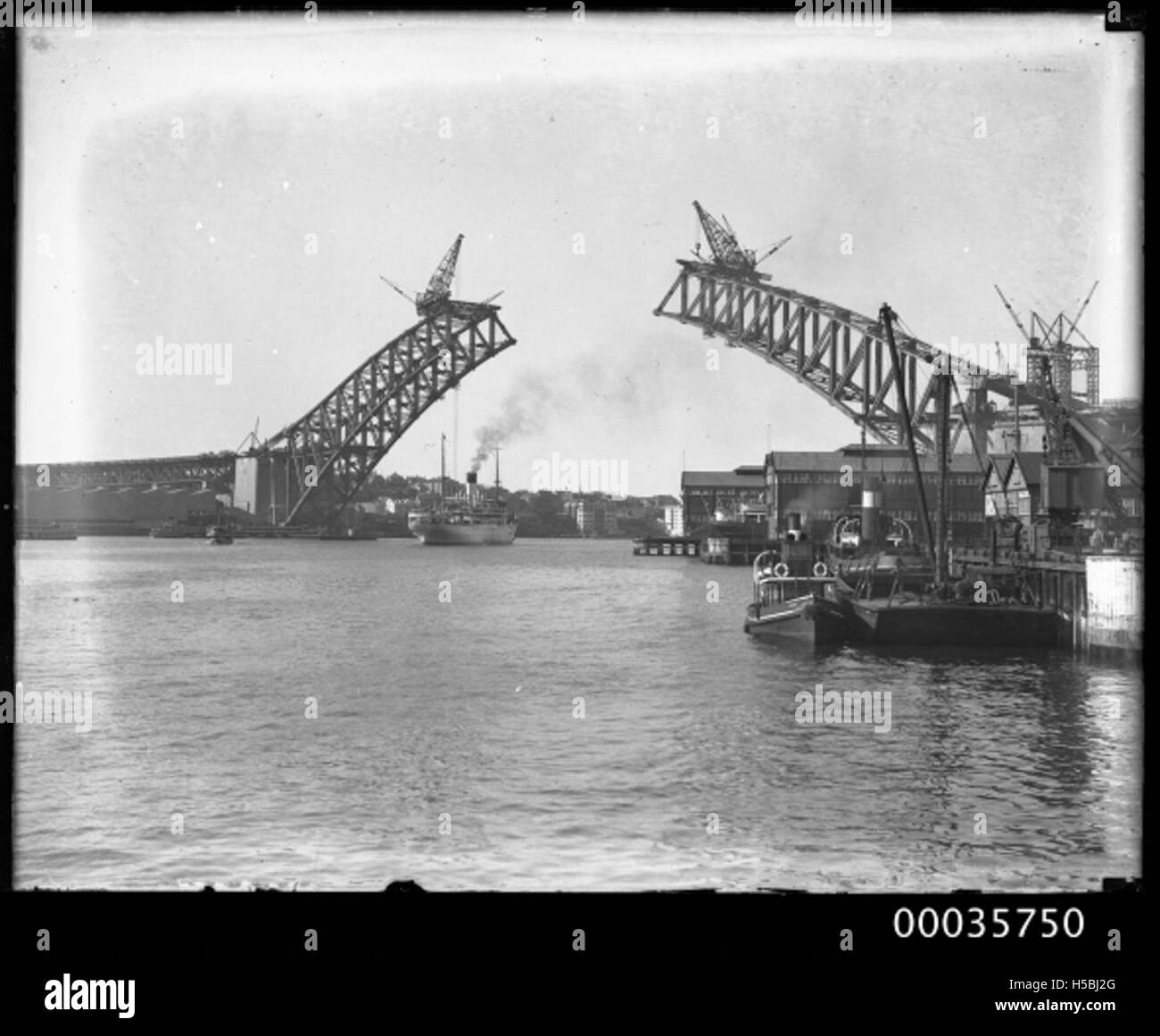 The Sydney Harbour Bridge, under construction in the 1930s, represents ...