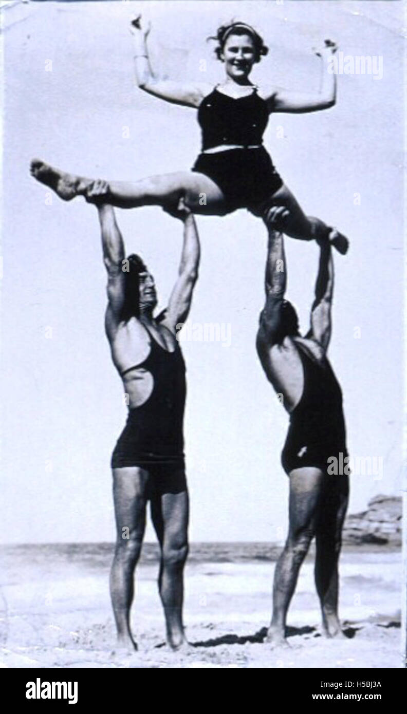 This photograph captures acrobats performing on the beach, a display of ...