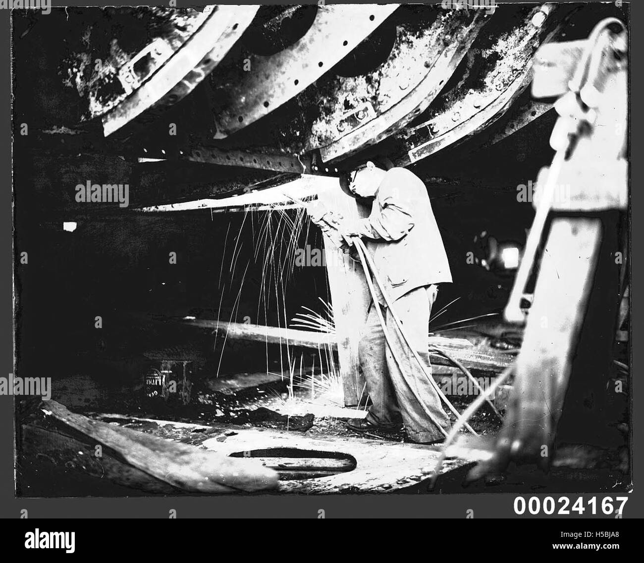A man is shown repairing the MONTORO between 1911 and 1945. This ...