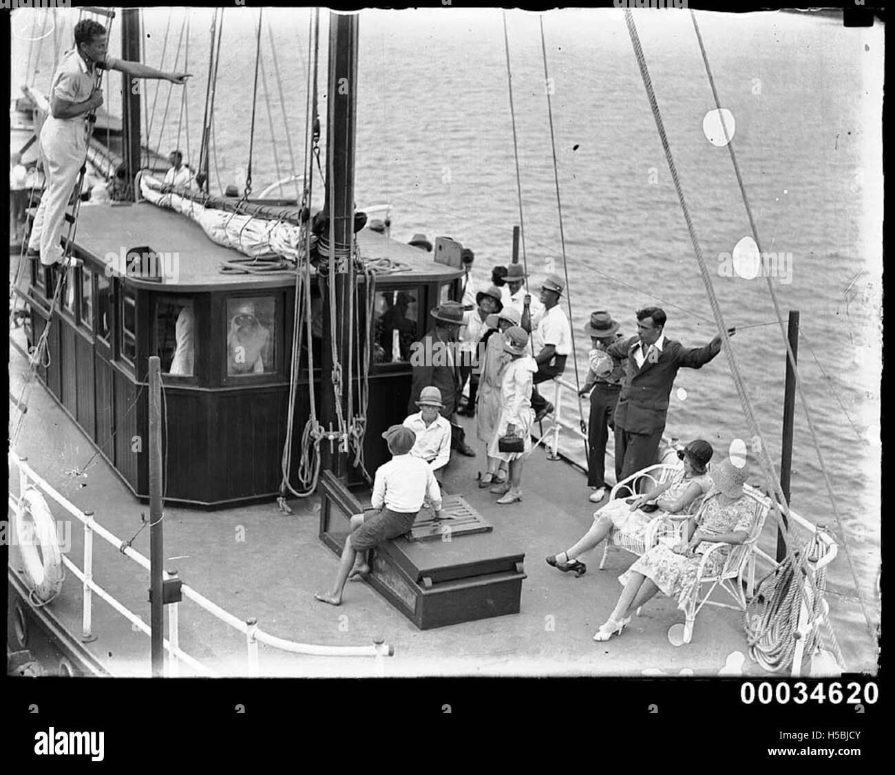 A photograph featuring a group of people aboard a sailing vessel, taken ...