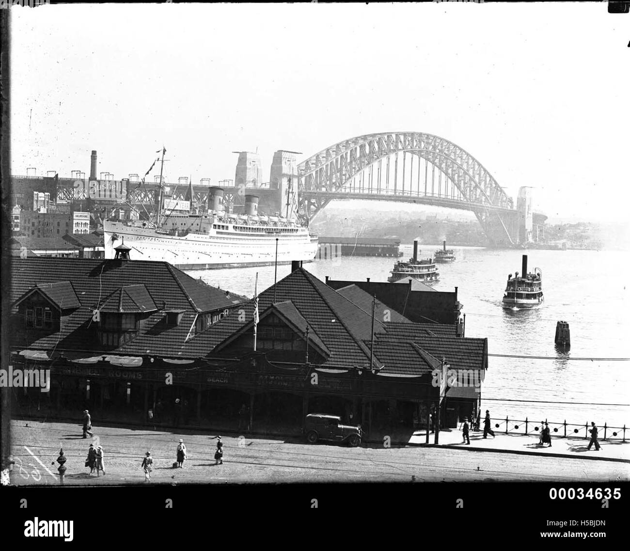 The nearly completed Sydney Harbour Bridge is captured in February 1932 ...