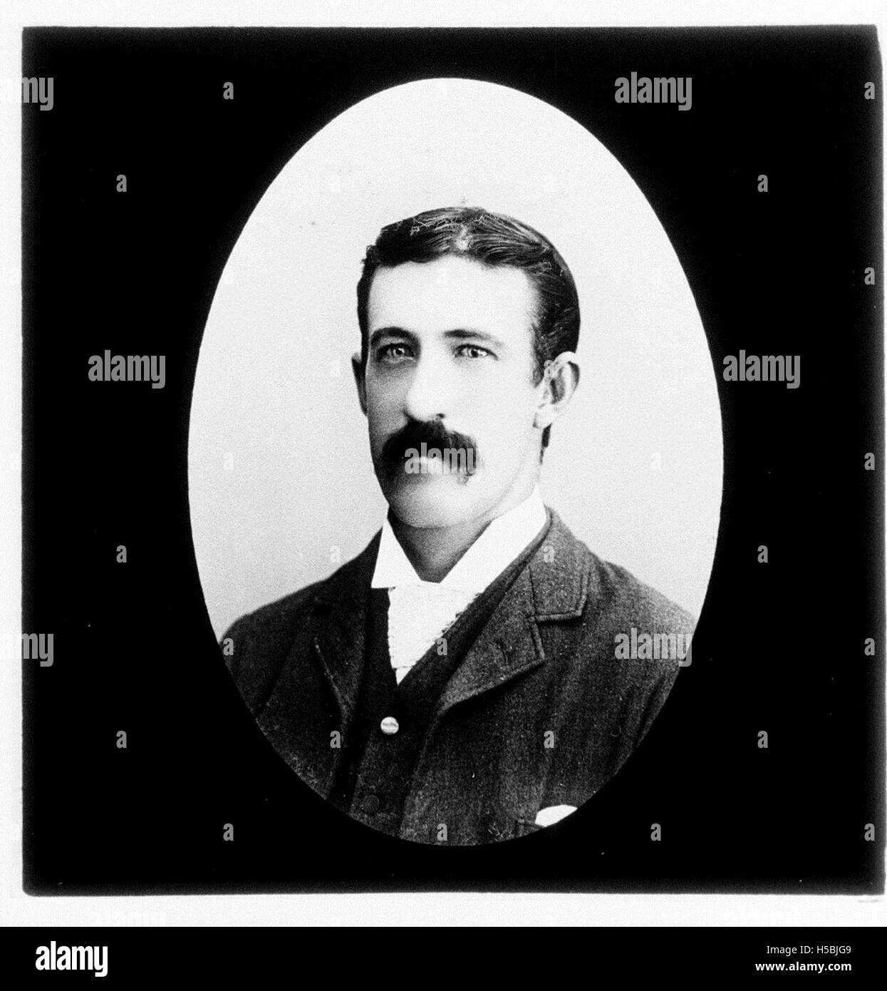 This portrait features a man with a distinctive moustache, emphasizing ...