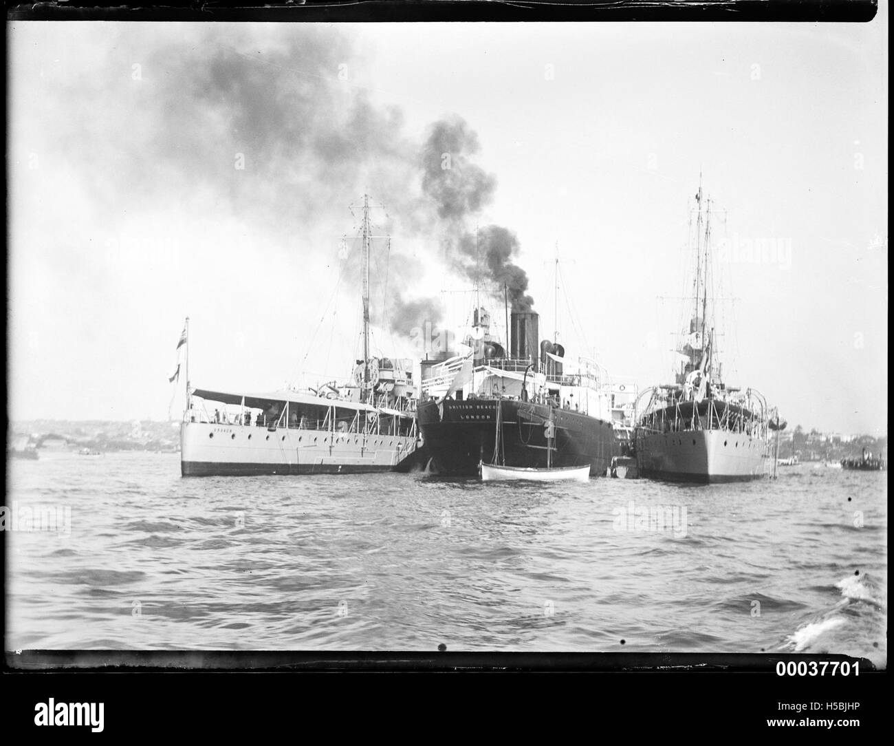 HMS DRAGON, BRITISH BEACON, and HMS DUNEDIN are shown anchored off ...