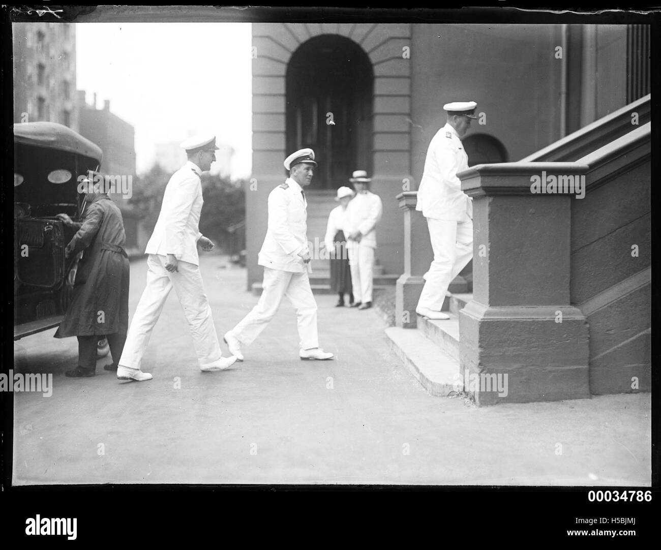 The image shows Royal Australian Navy officers ascending the steps at ...