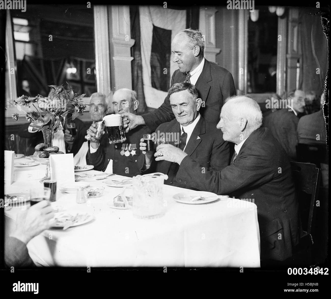Retired military personnel are pictured gathered around a table ...