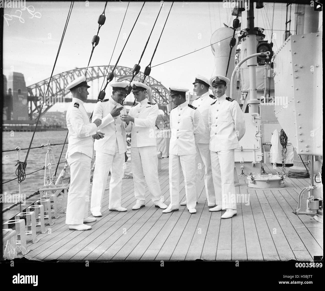 Royal Indian Navy officers are photographed on the deck of the *HMIS ...
