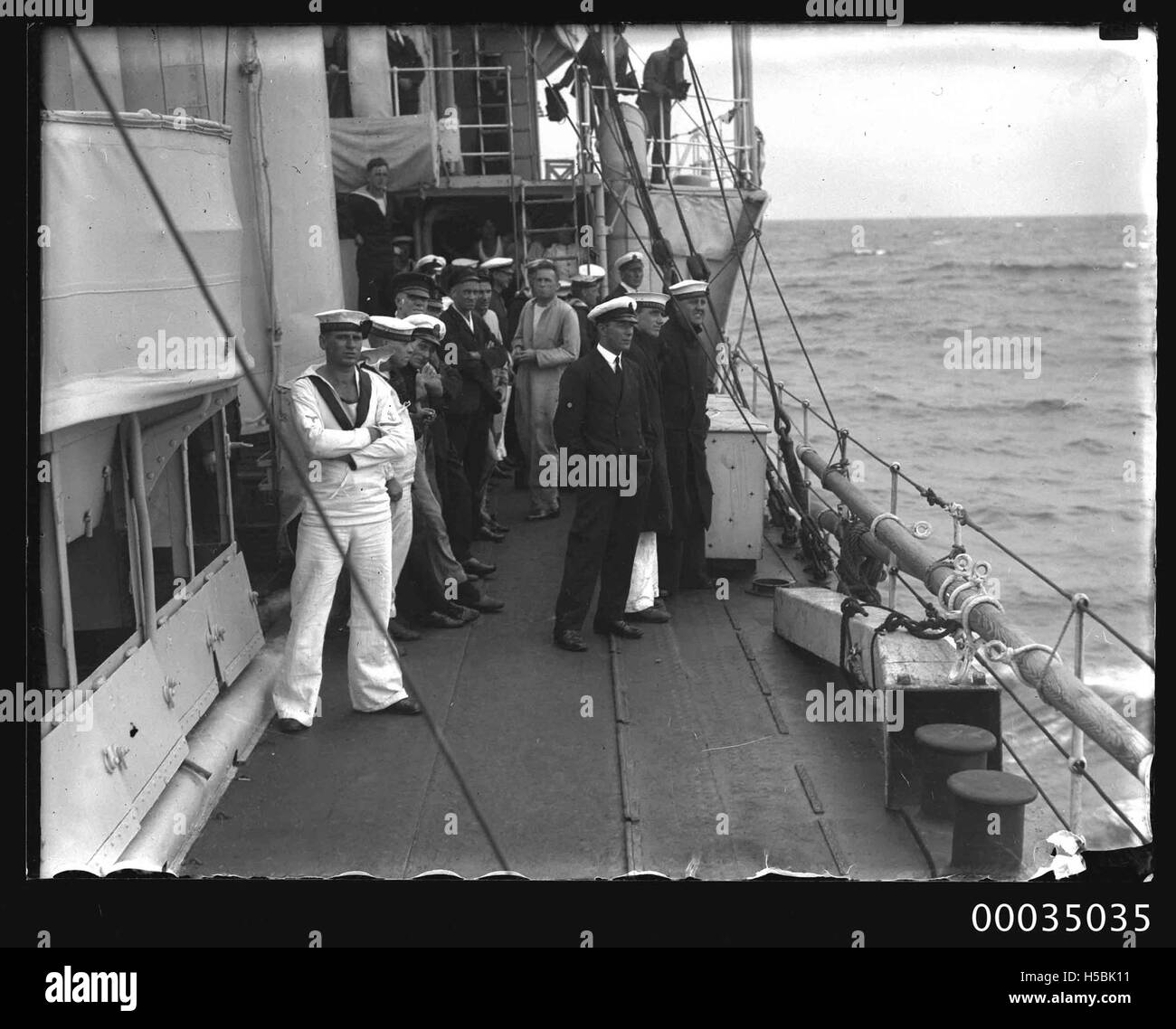 This image captures naval officers and sailors observing the sinking of ...