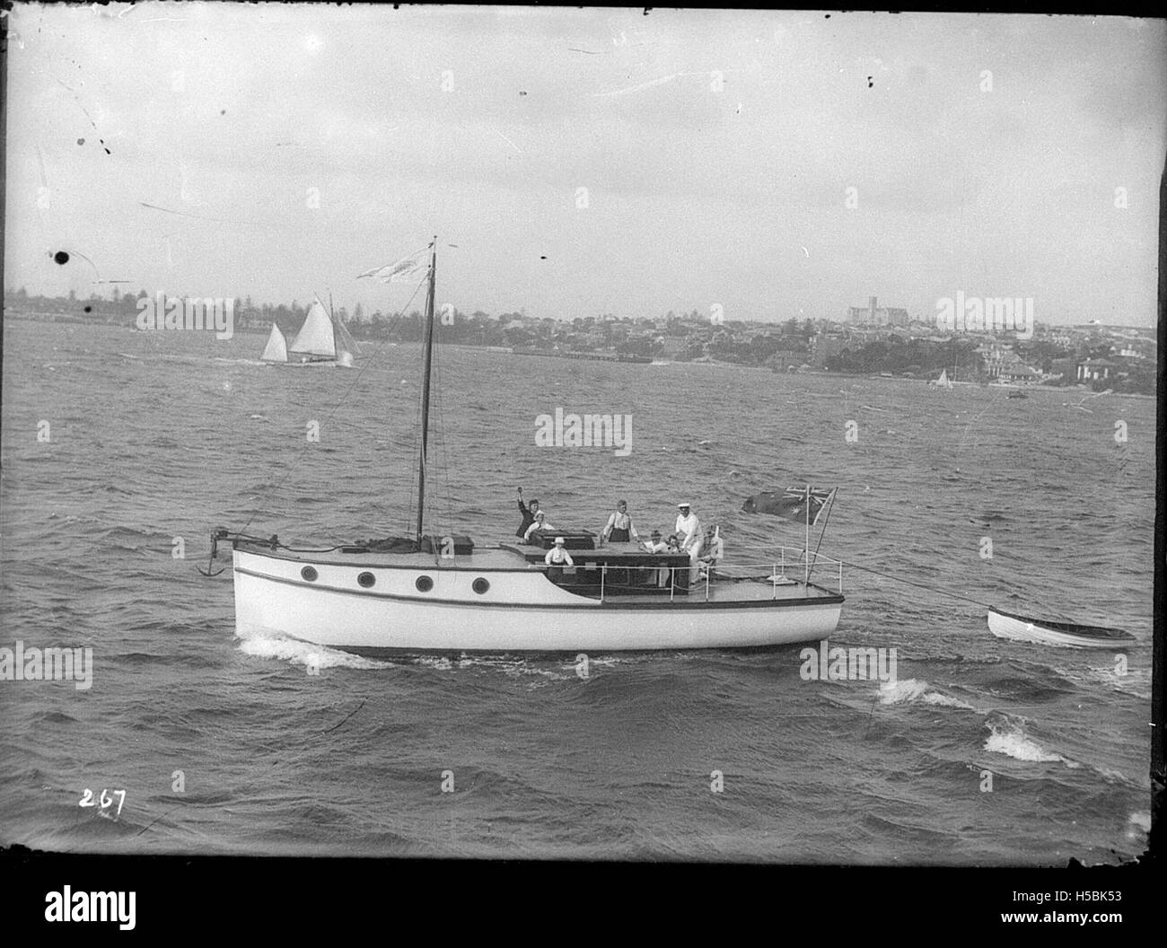 This image captures a raised deck motor launch near Manly, Sydney, a ...