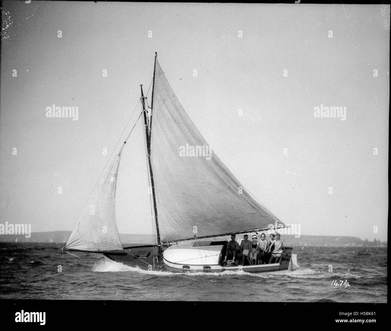 A sloop is seen sailing on Sydney Harbour, carrying six people onboard ...