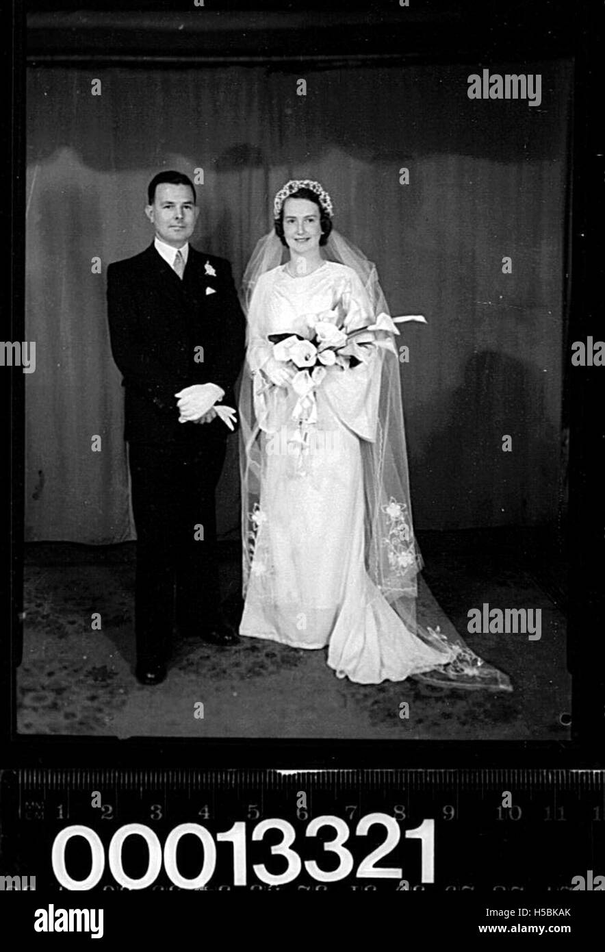 A formal portrait of a bride and groom on their wedding day. The image ...