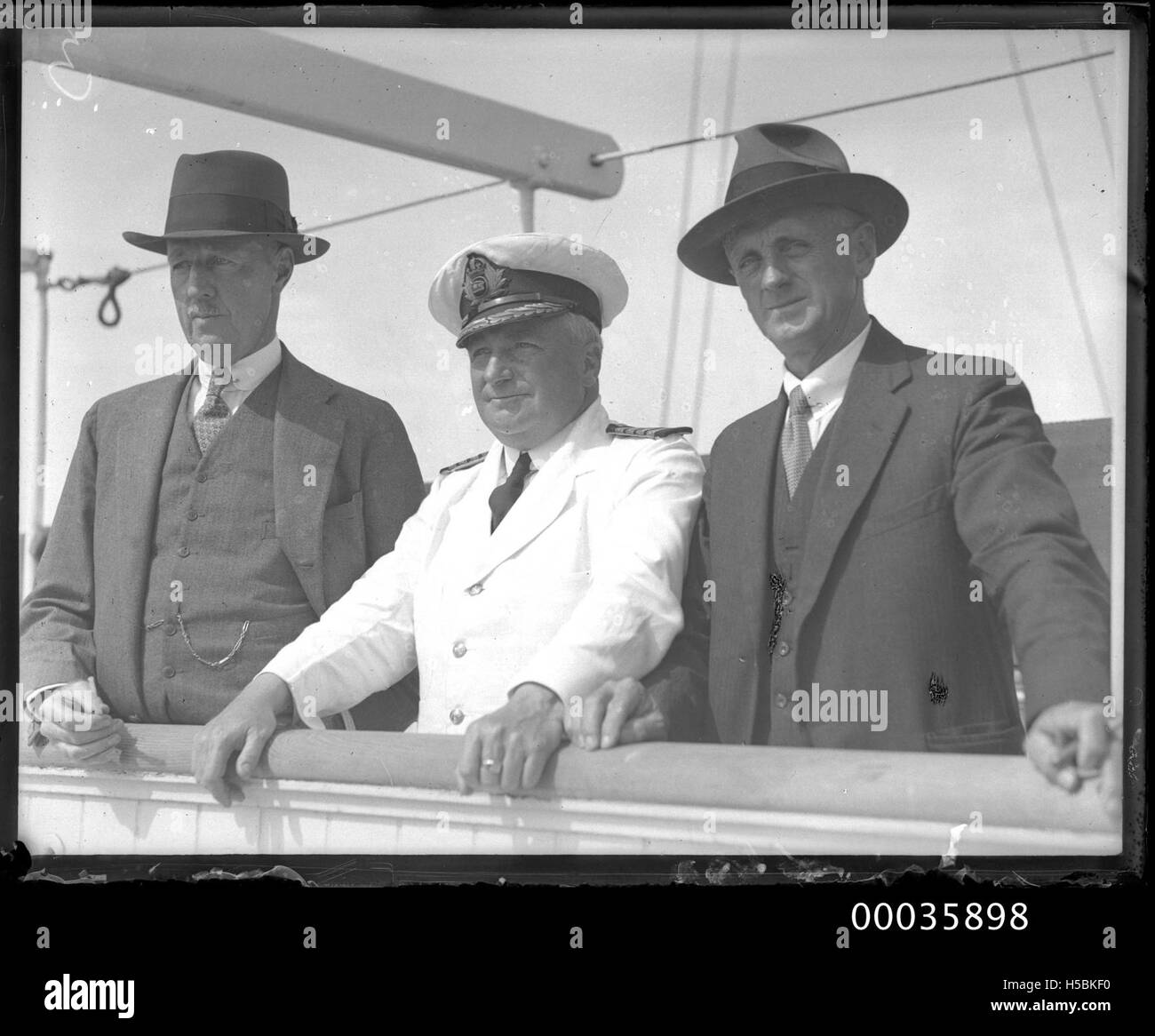 A photograph featuring the captain and two passengers on the deck of ...
