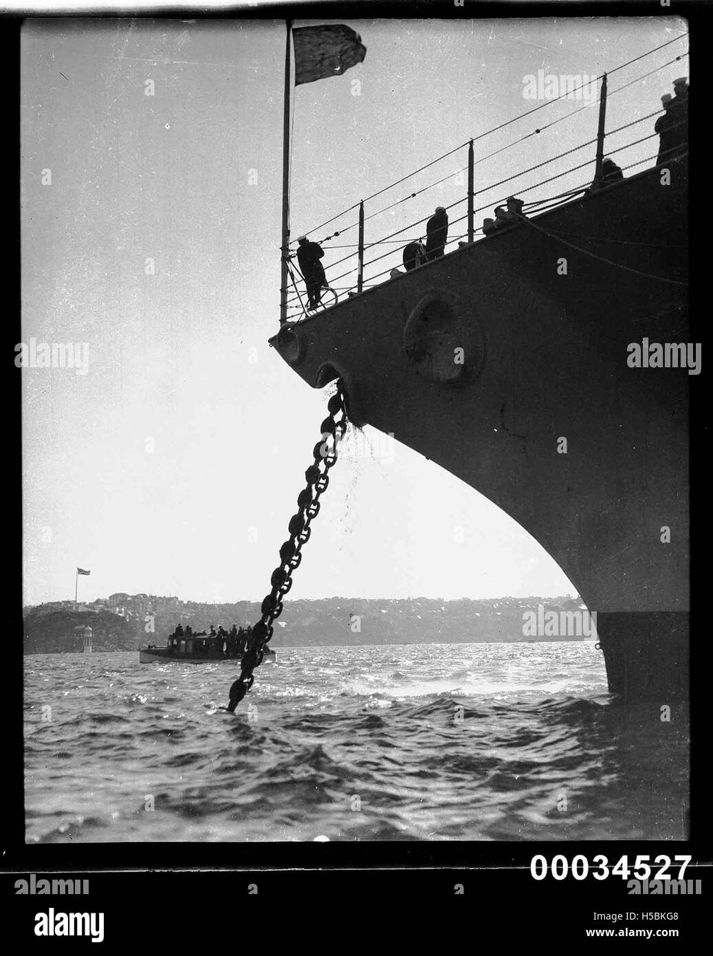 This image shows a bow view of a United States Navy warship anchored ...