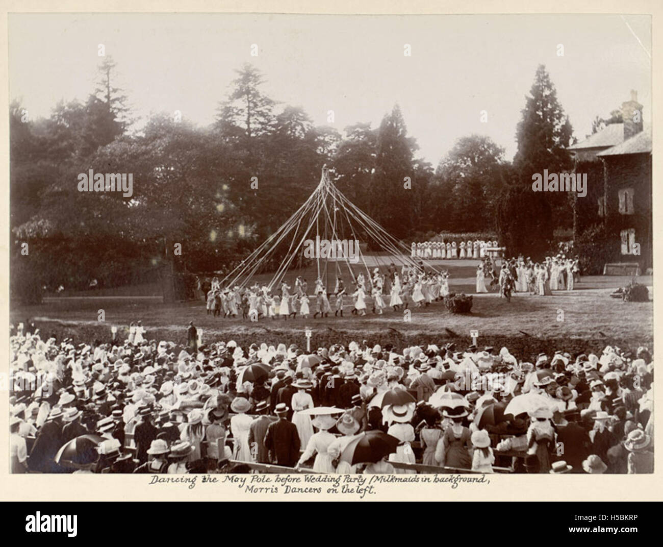 This scene depicts people dancing the Maypole in front of a wedding ...
