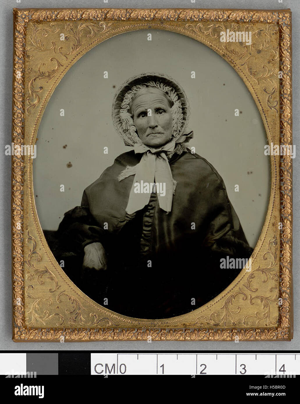 An elderly lady is depicted wearing a traditional bonnet. The bonnet, a ...