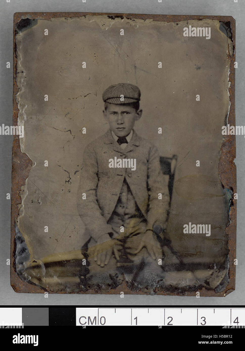 A tintype photograph of a boy, likely from the late 19th or early 20th ...