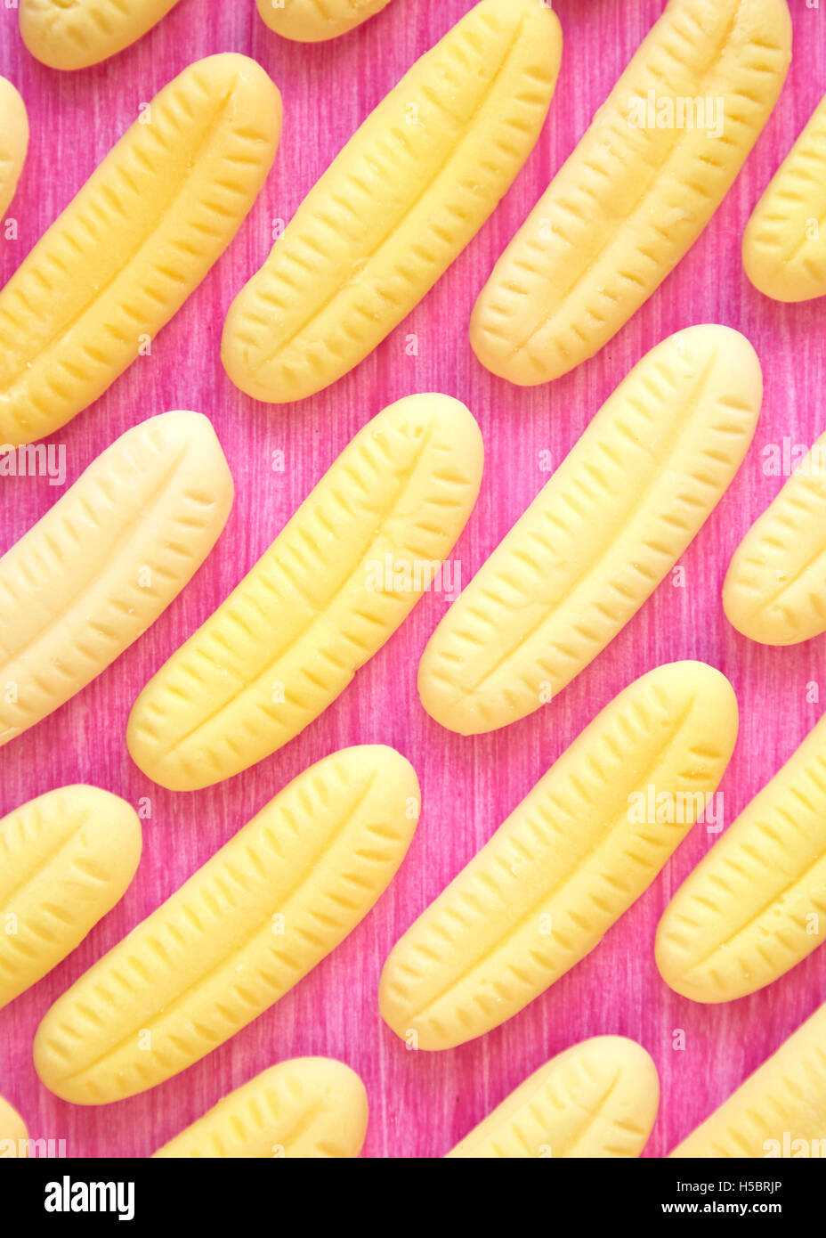 Banana sweets, Yellow, pink background Stock Photo - Alamy