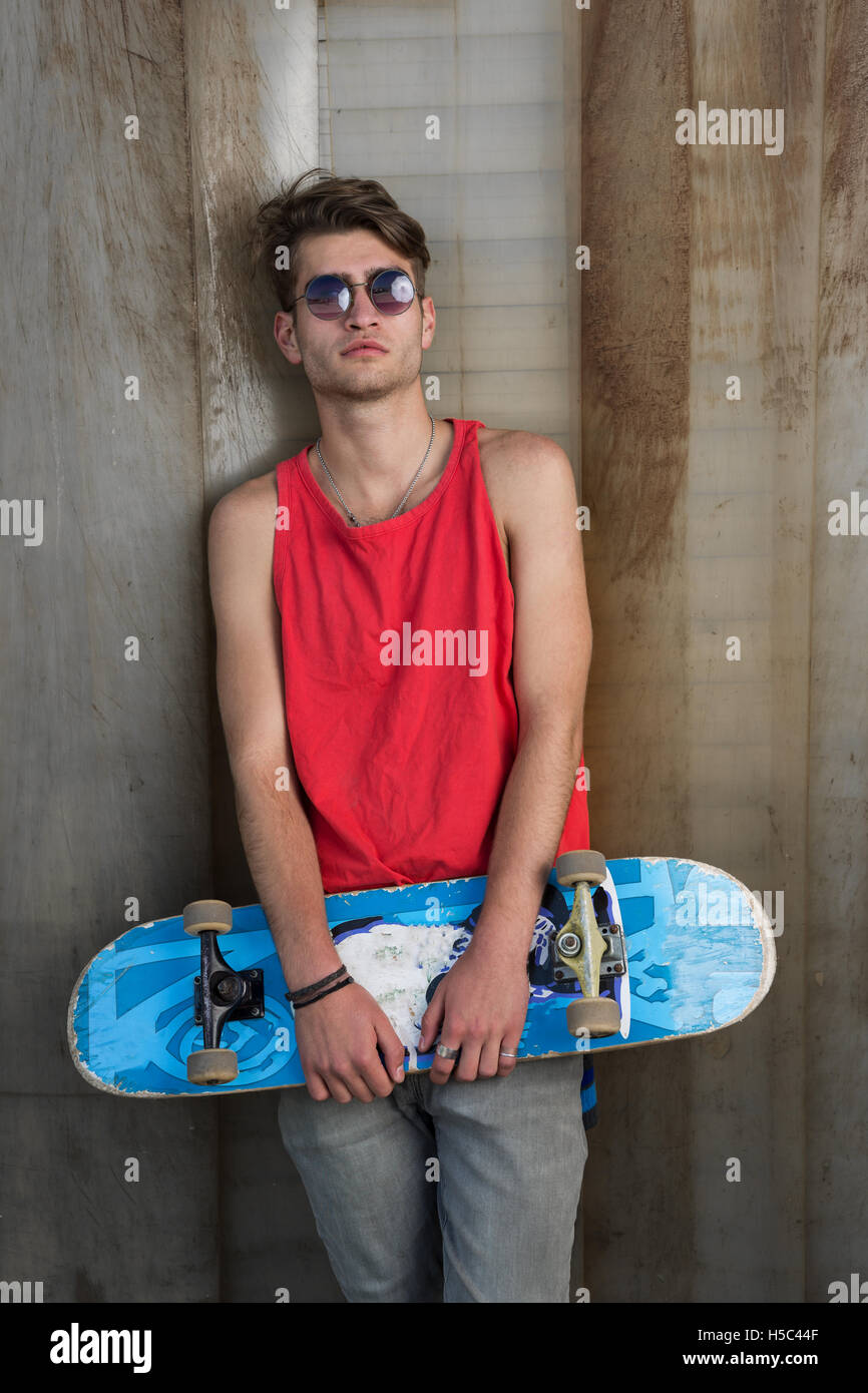 fashionable guy with skateboard Stock Photo - Alamy